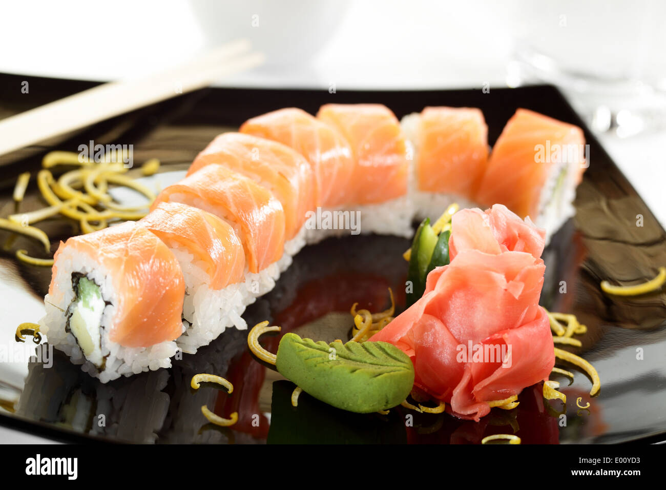cold sushi on black dish and white background Stock Photo - Alamy