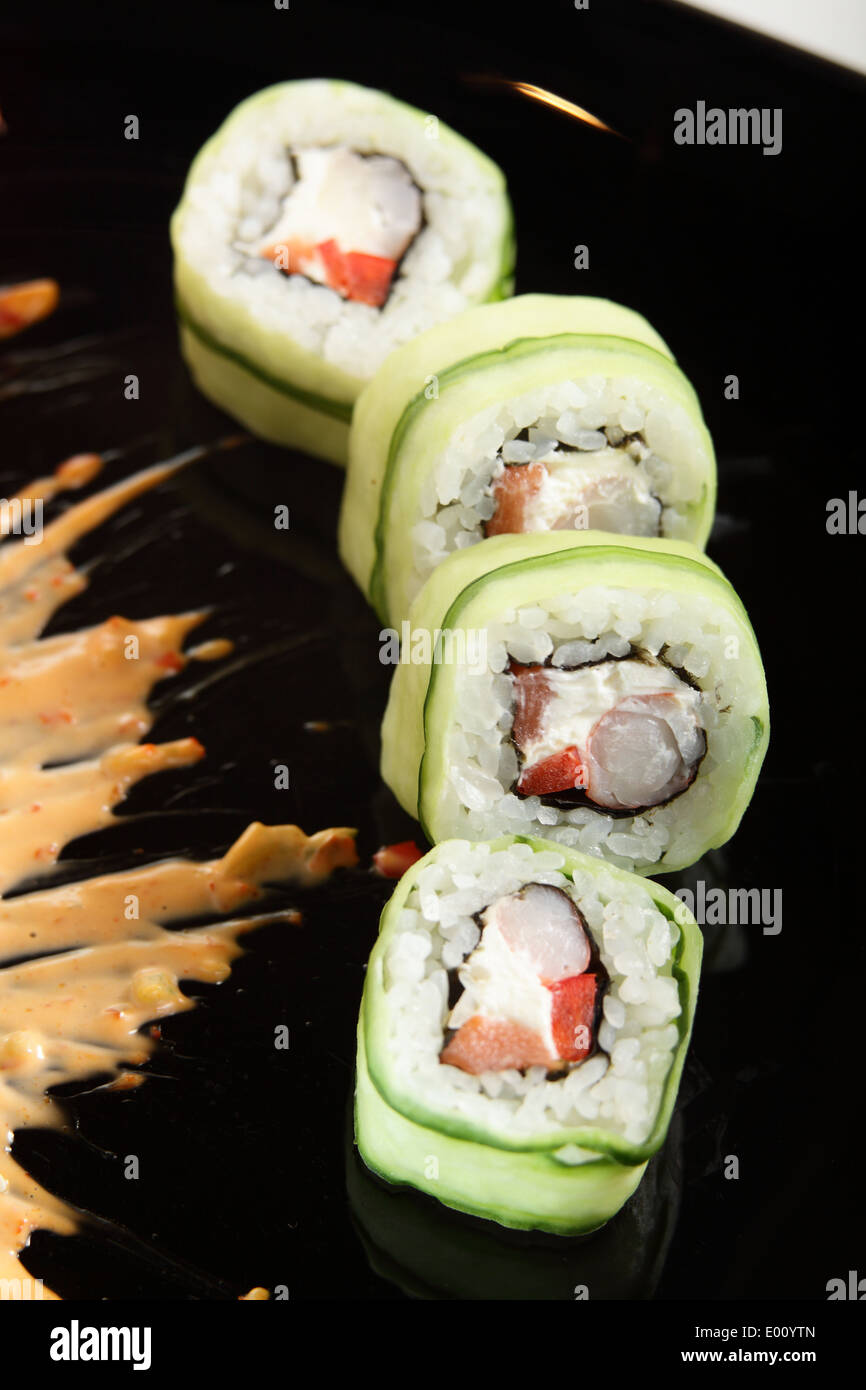 cold sushi on black dish and white background Stock Photo - Alamy