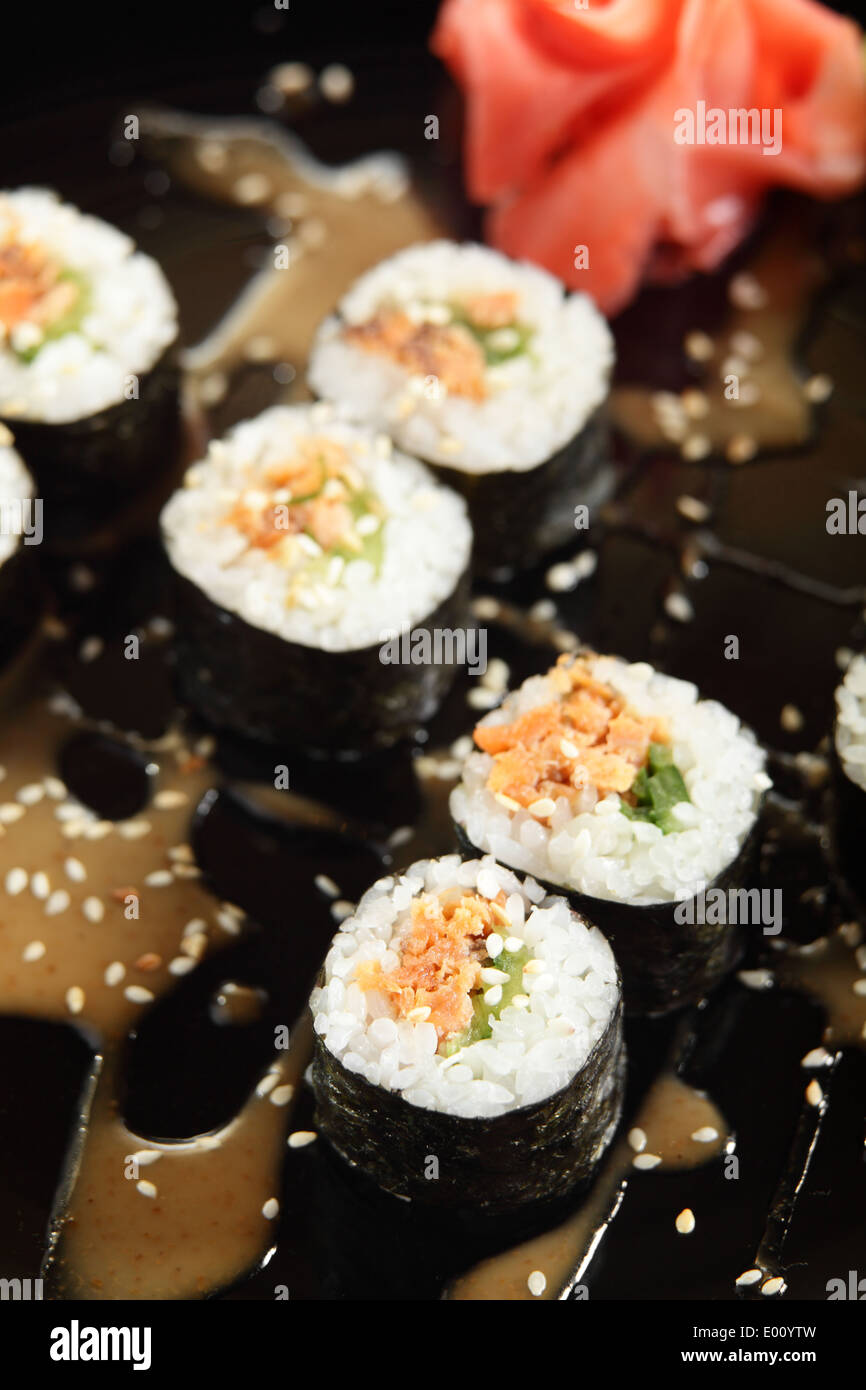 cold sushi on black dish and white background Stock Photo - Alamy