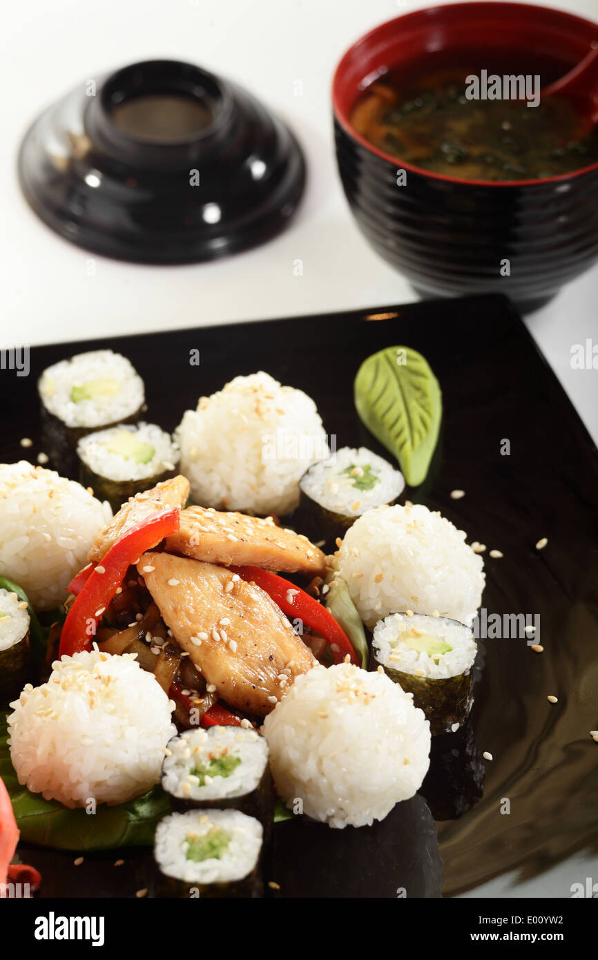 cold sushi on black dish and white background Stock Photo - Alamy