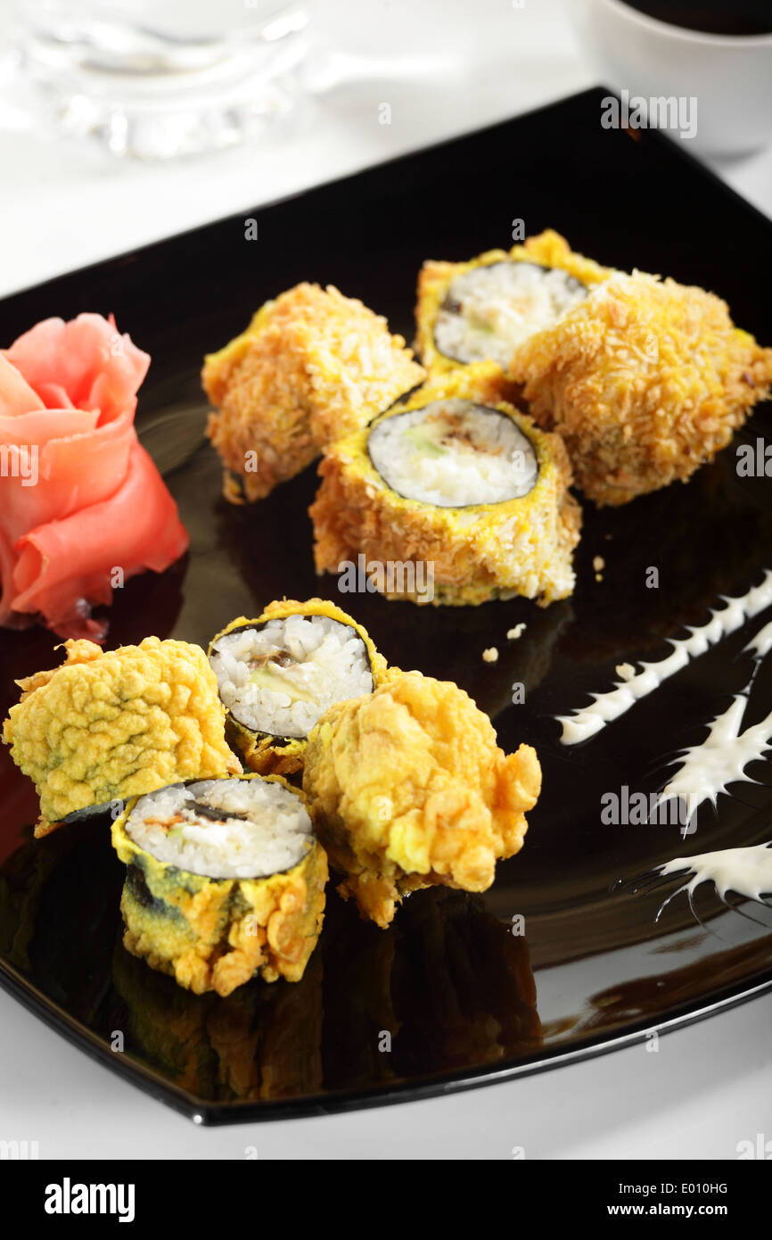 cold sushi on black dish and white background Stock Photo - Alamy