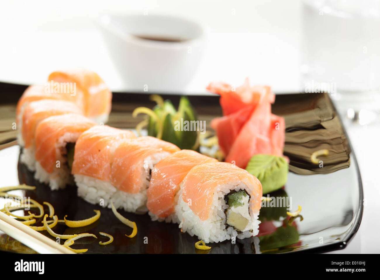 cold sushi on black dish and white background Stock Photo - Alamy