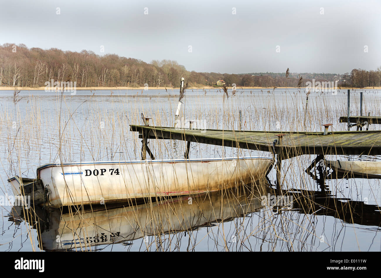 old dilapidated bridge with one old boats Stock Photo - Alamy