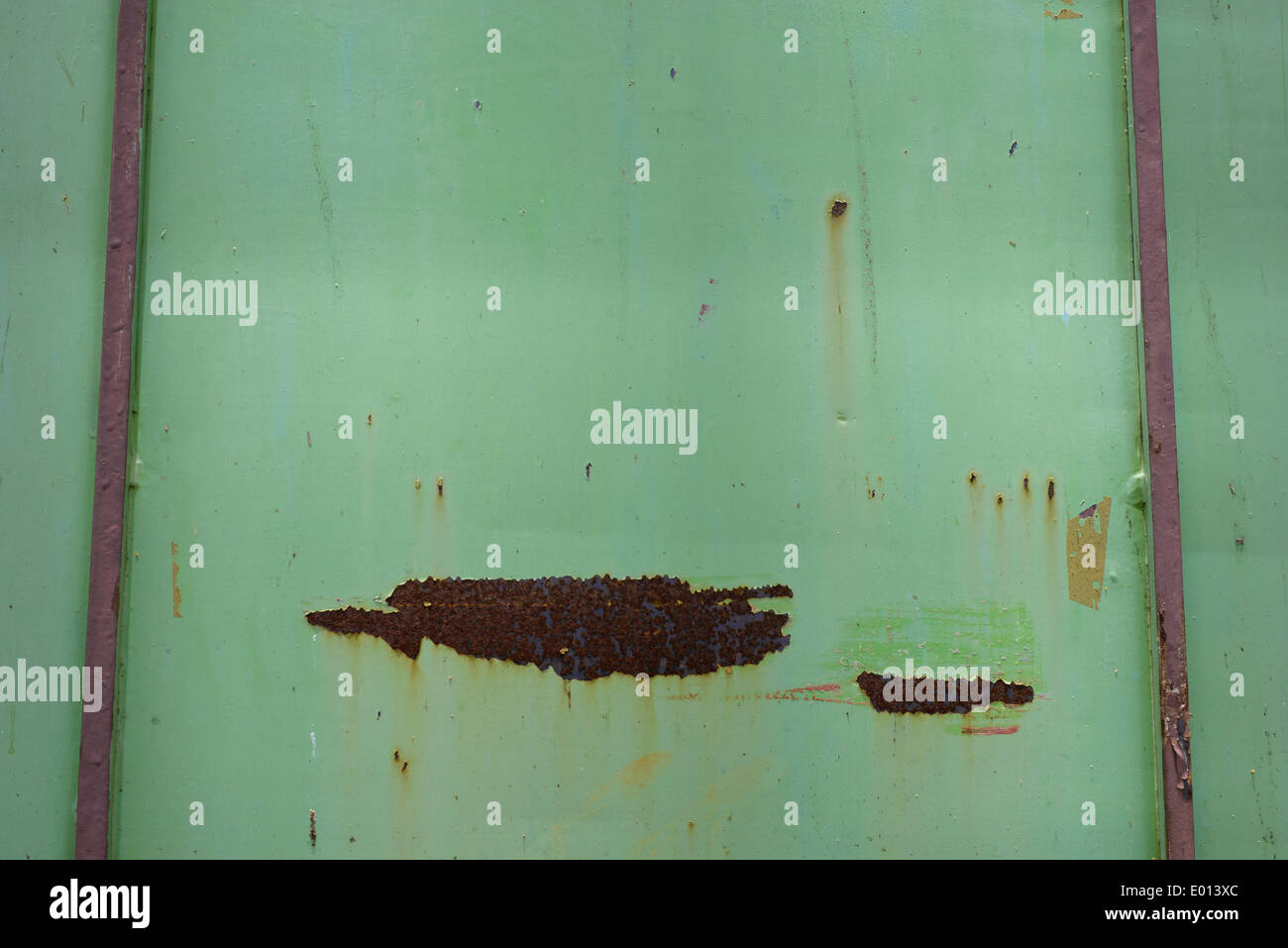 A rustic, industrial green metal wall, old, worn and rusty. Surface has ...