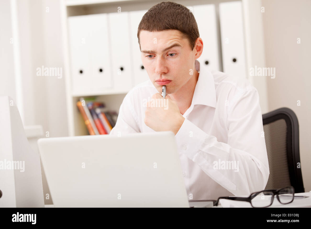 man thinking in office Stock Photo - Alamy