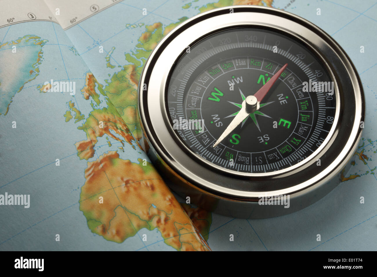 Compass on Earth map background Stock Photo - Alamy