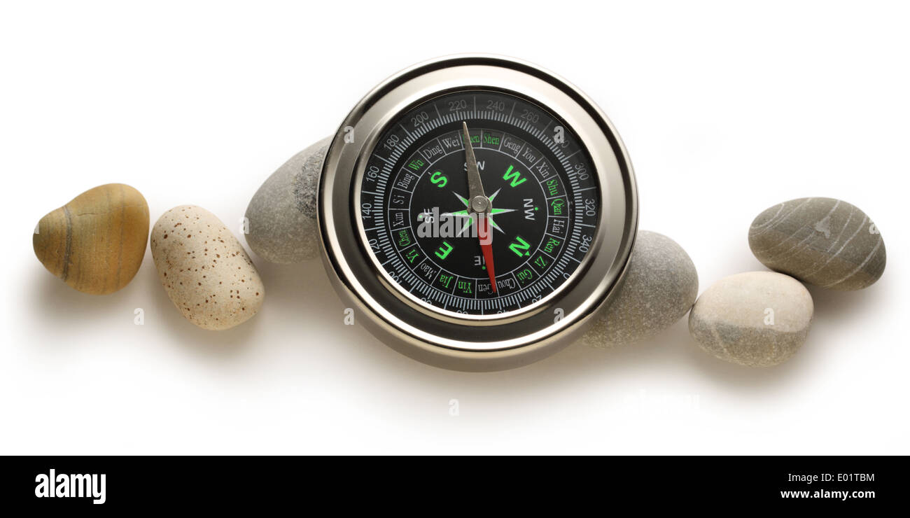 Compass and sea stones on white Stock Photo - Alamy