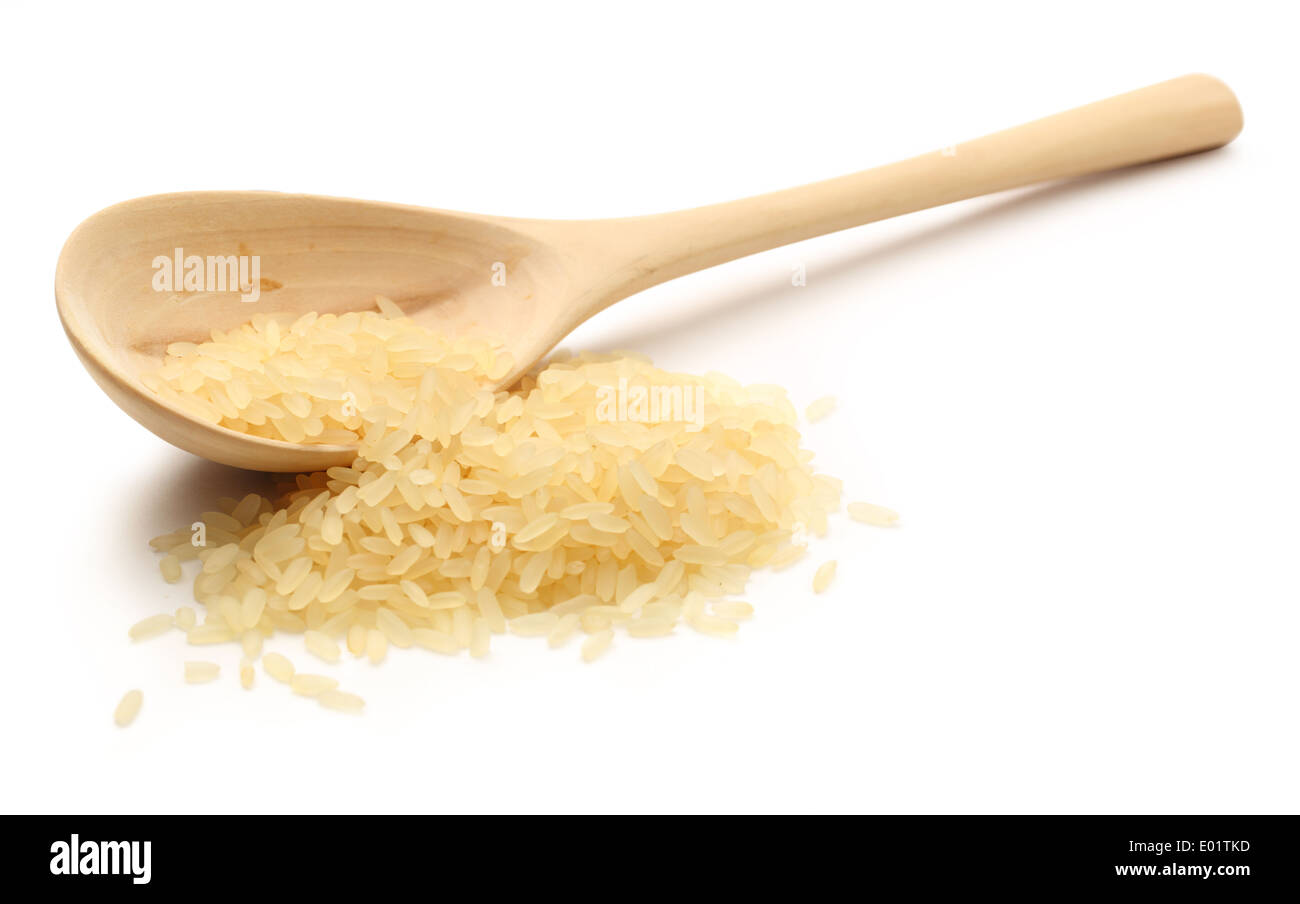 Heap of rice with wooden spoon on white Stock Photo - Alamy