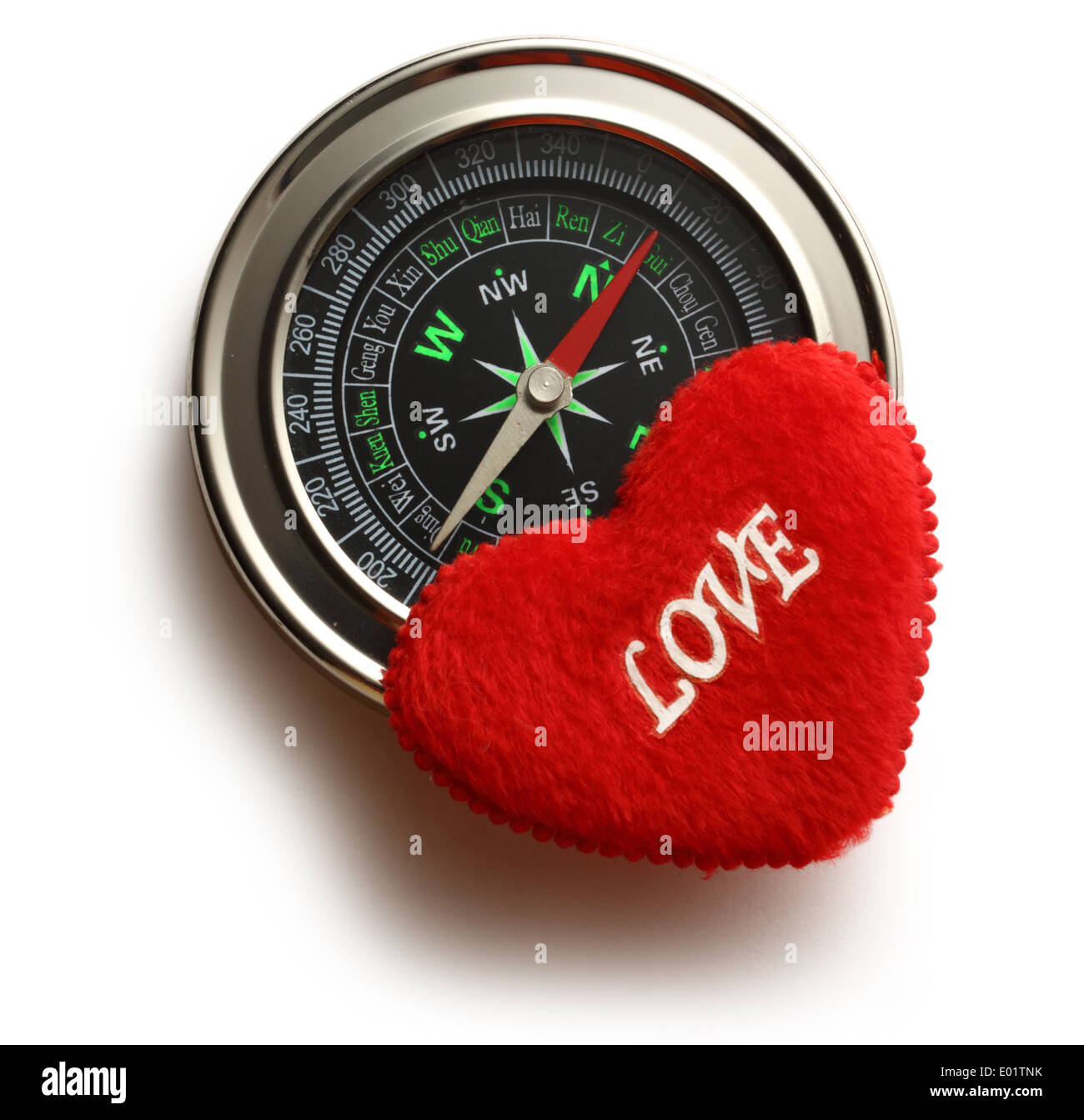 Compass and red heart with love word Stock Photo - Alamy