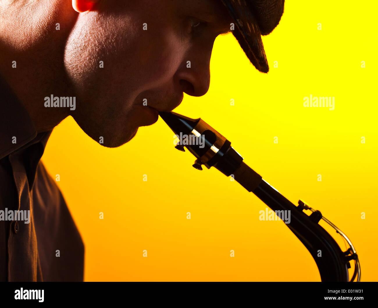 Portrait of the man playing a saxophone Stock Photo - Alamy
