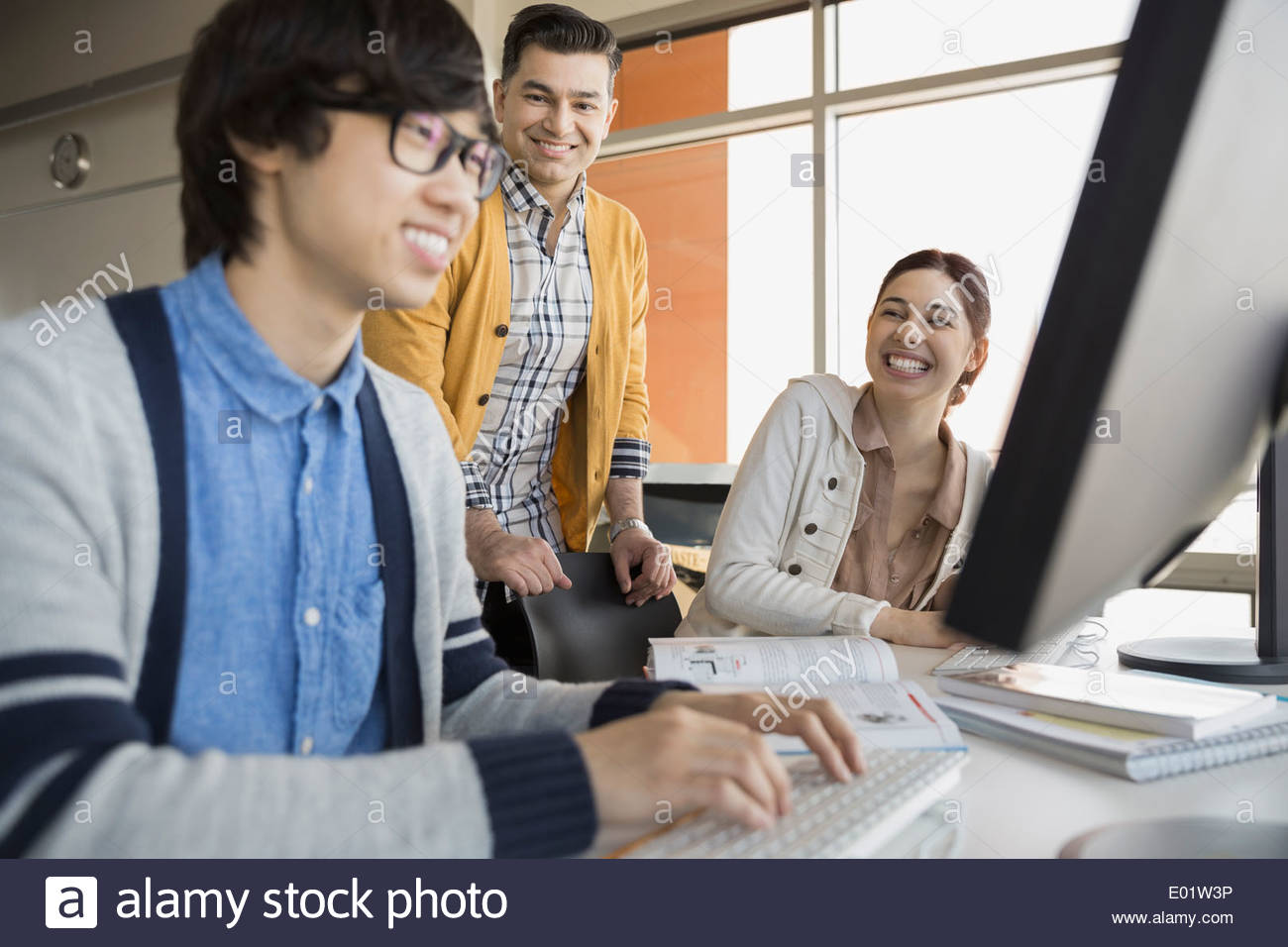 Indian teacher with students at computer hi-res stock photography and ...