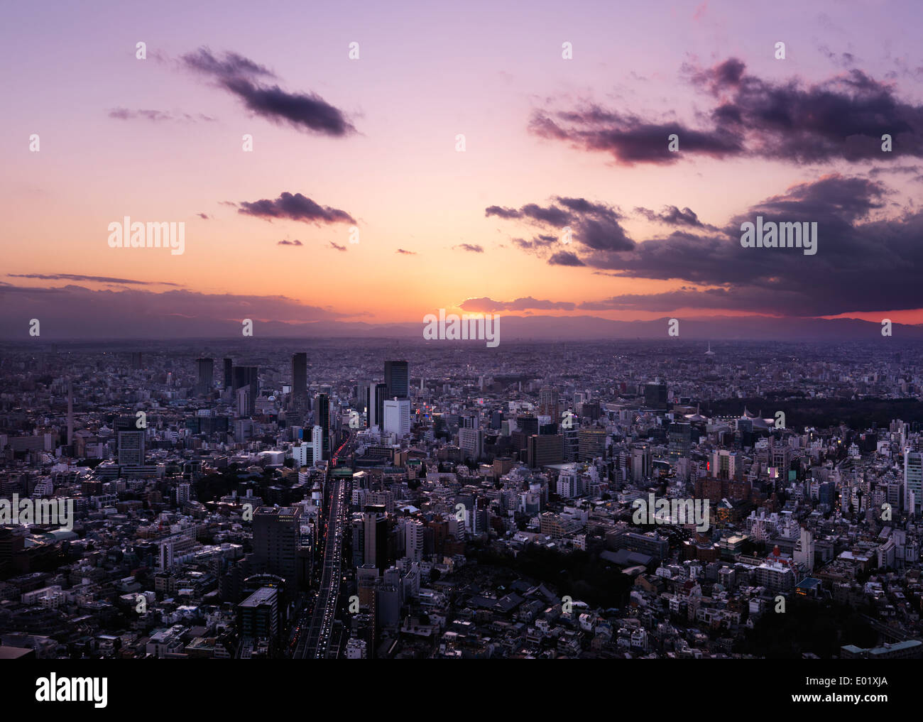 Dramatic sunset scenery of Tokyo city landscape lit with red sunlight ...