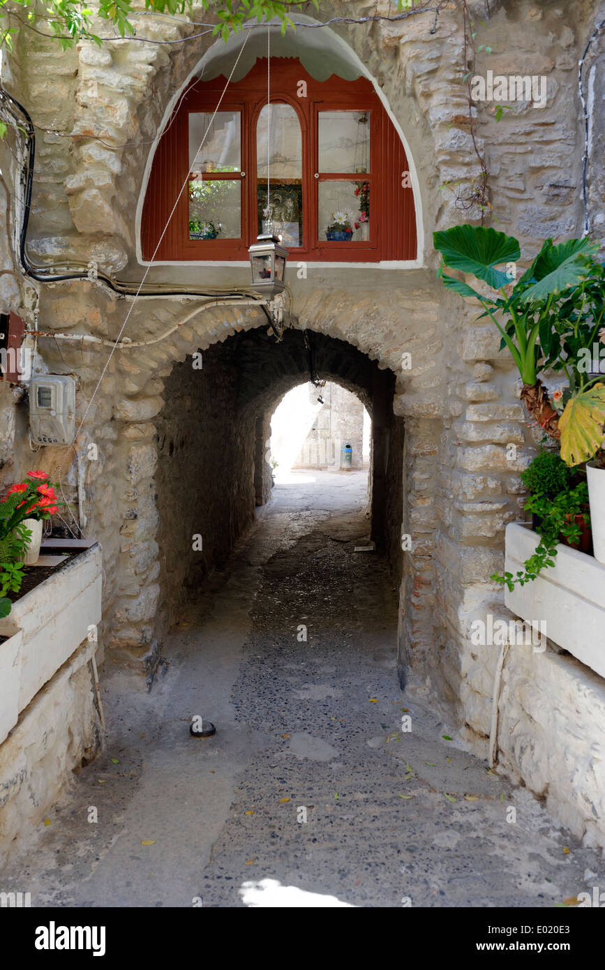 Vaulted arched narrow cobblestone lane lined with stone houses Medieval ...
