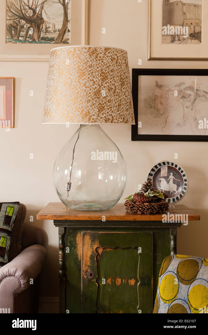 A TMO glass bottle lamp on an old green Romanian cupboard Stock Photo ...