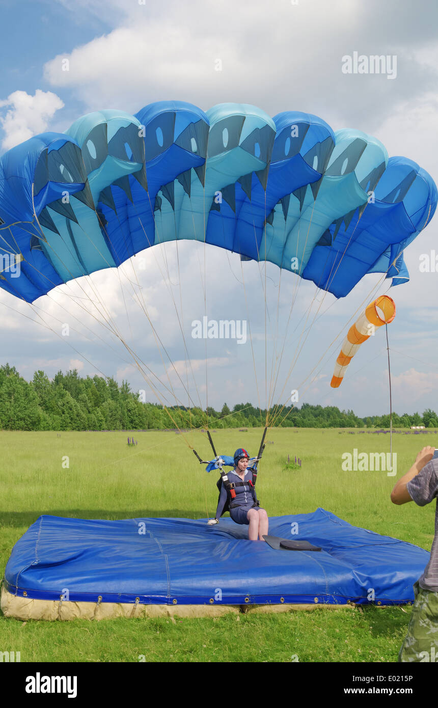 One day with parachutist in airfield. The girl-skydiver lands under the ...
