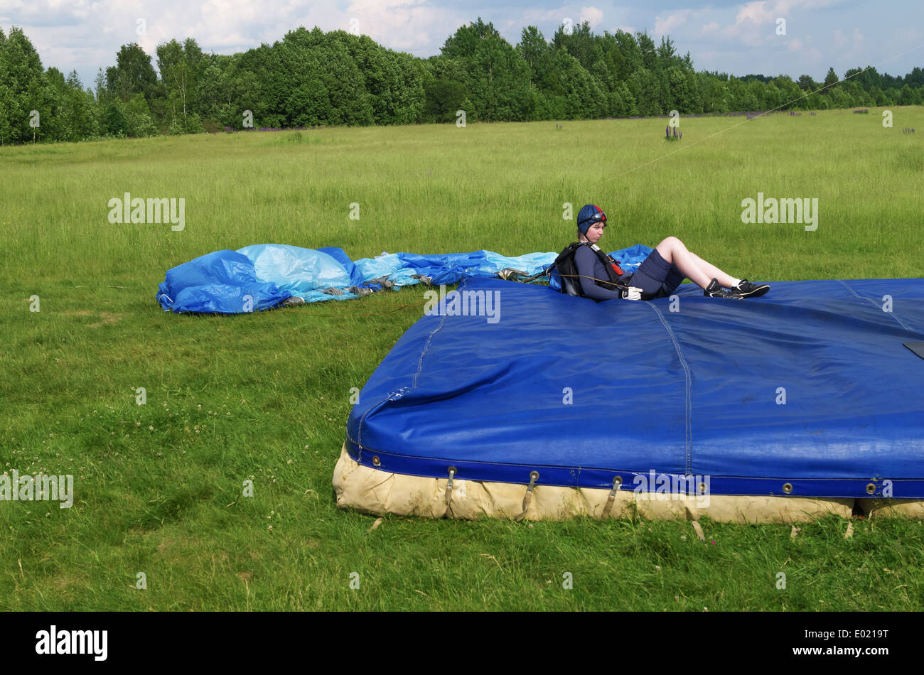 One day with parachutist in airfield. The girl-skydiver after landing ...