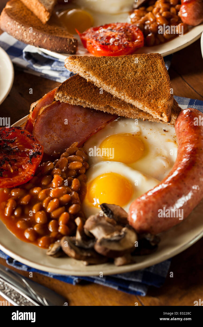 Traditional Full English Breakfast with Eggs, Bacon, Sausage, and Baked ...