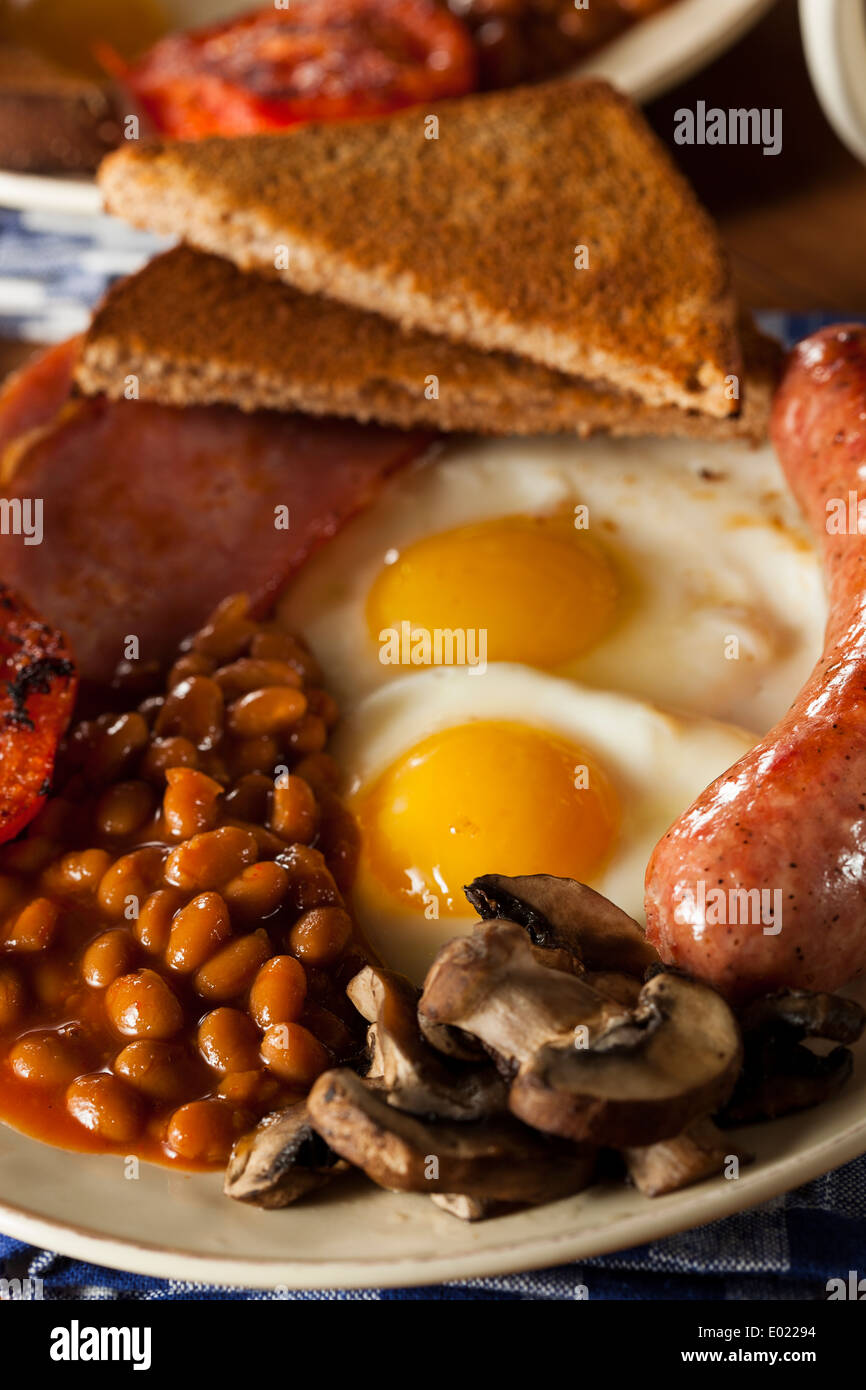 Traditional Full English Breakfast with Eggs, Bacon, Sausage, and Baked ...