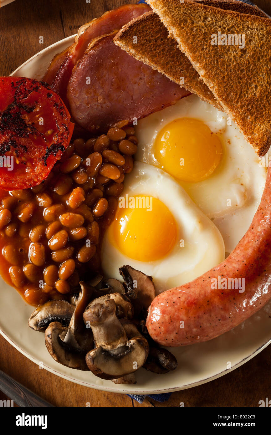 Traditional Full English Breakfast with Eggs, Bacon, Sausage, and Baked ...