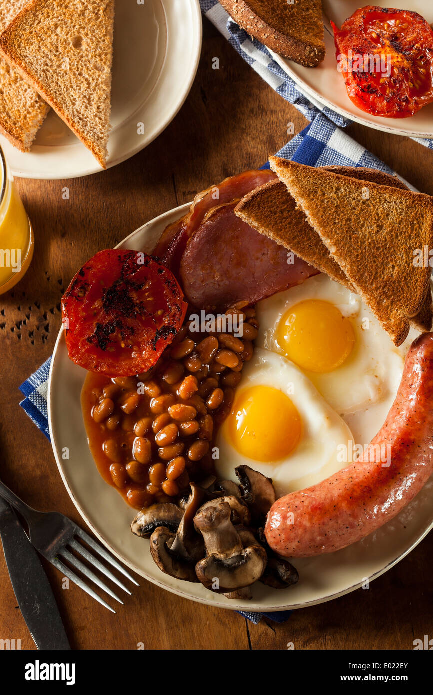 Traditional Full English Breakfast with Eggs, Bacon, Sausage, and Baked ...