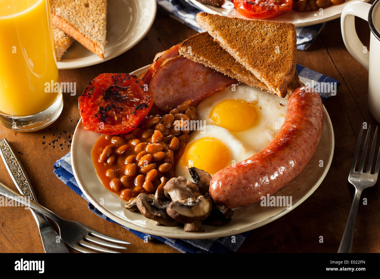 Traditional Full English Breakfast with Eggs, Bacon, Sausage, and Baked ...