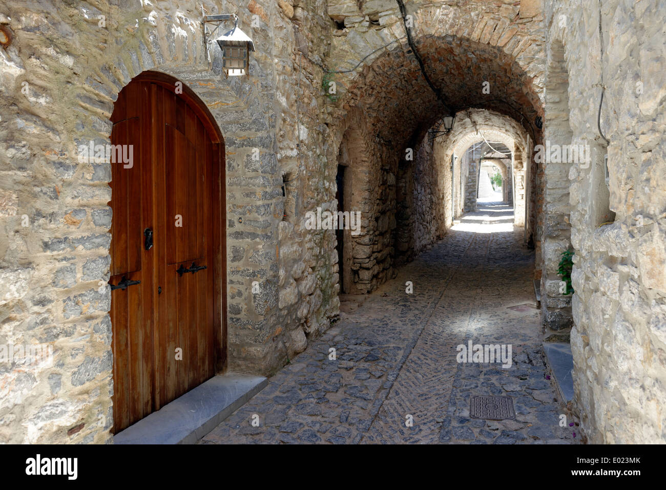 Vaulted arched narrow cobblestone lane lined with stone houses Medieval ...