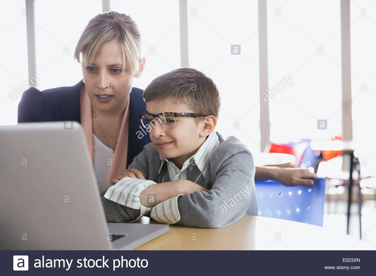 Boy and teacher in classroom hi-res stock photography and images - Alamy