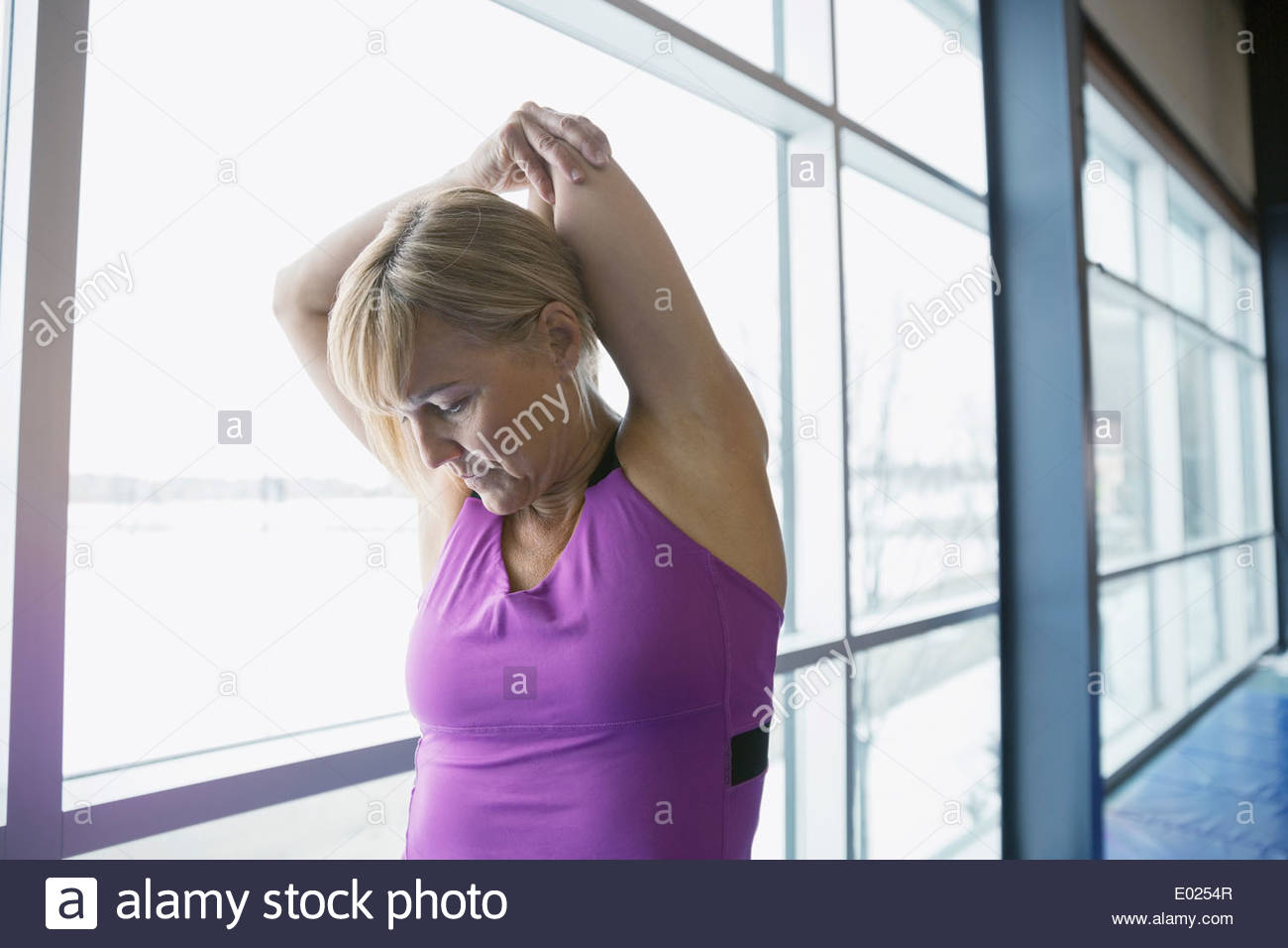 Woman stretching arms up standing hi-res stock photography and images ...