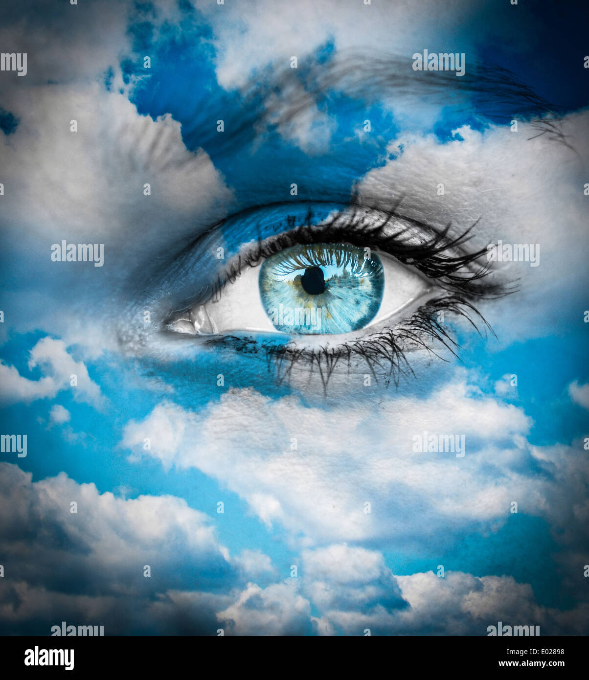 Beautiful blue eye against blue clouds - Spiritual concept Stock Photo ...