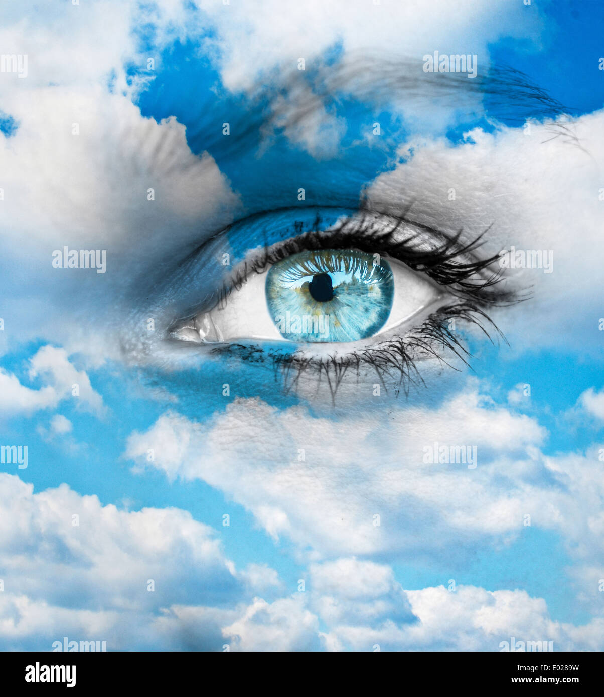 Beautiful blue eye against blue clouds - Spiritual concept Stock Photo ...