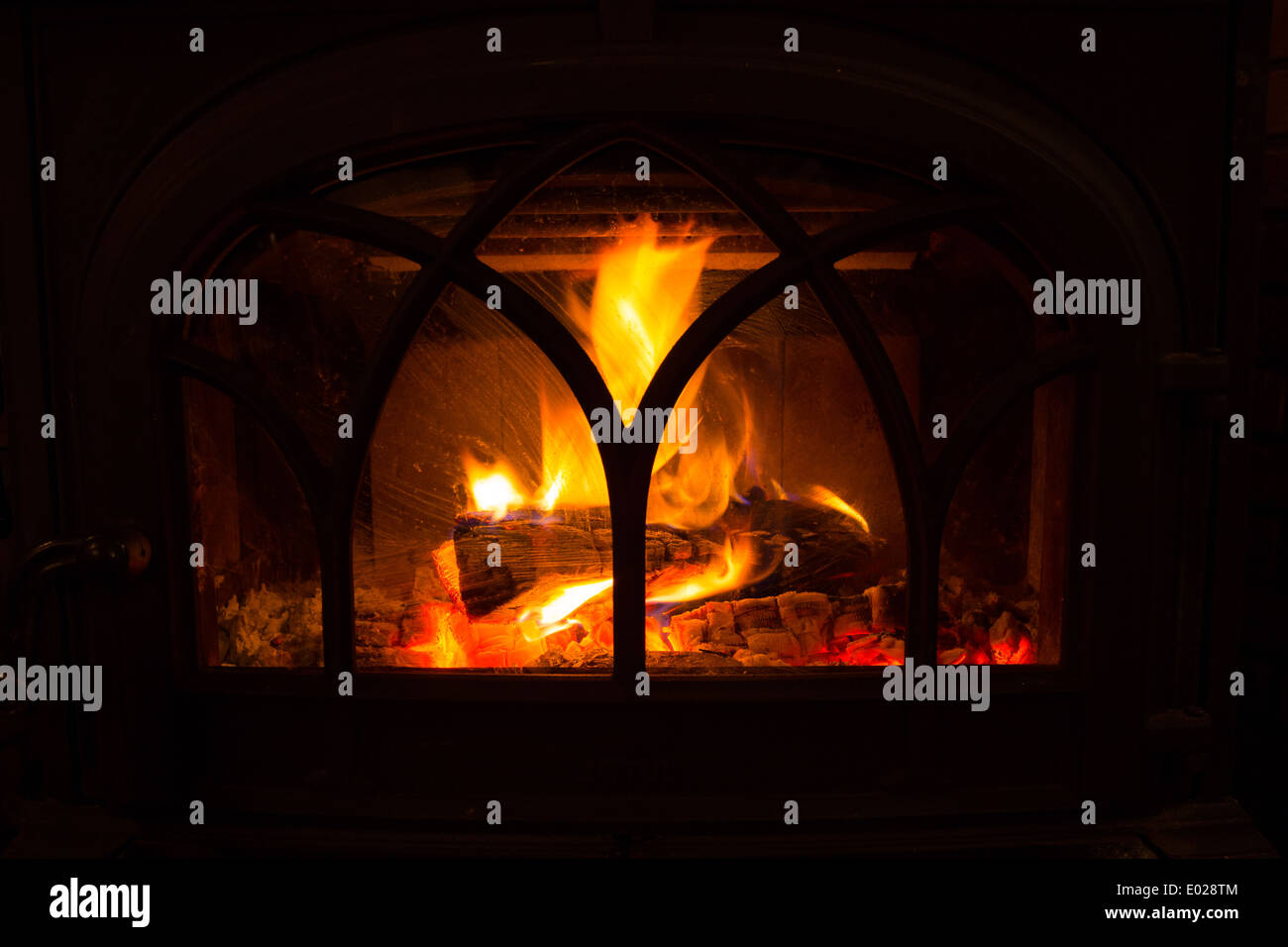 Fire burning in a wood stove at a lodge cabin Stock Photo - Alamy