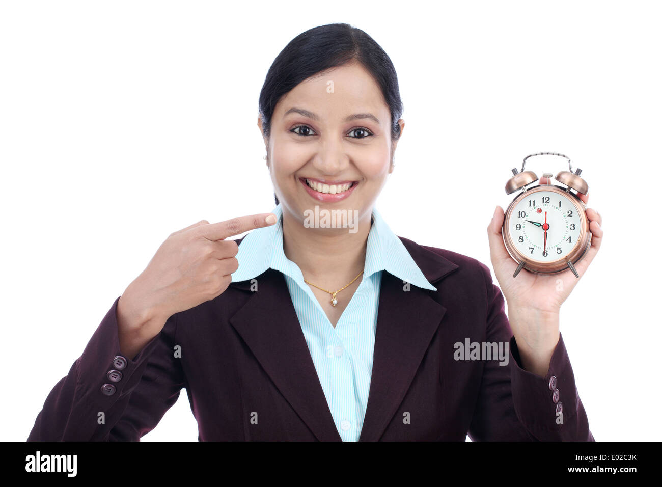 Young business woman with an alarm clock Stock Photo - Alamy