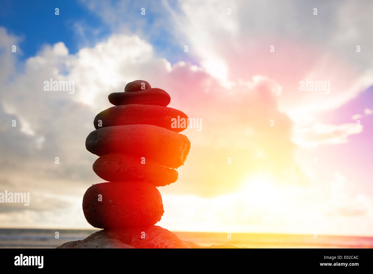 stones stack pyramid on a beach with sunset background Stock Photo - Alamy