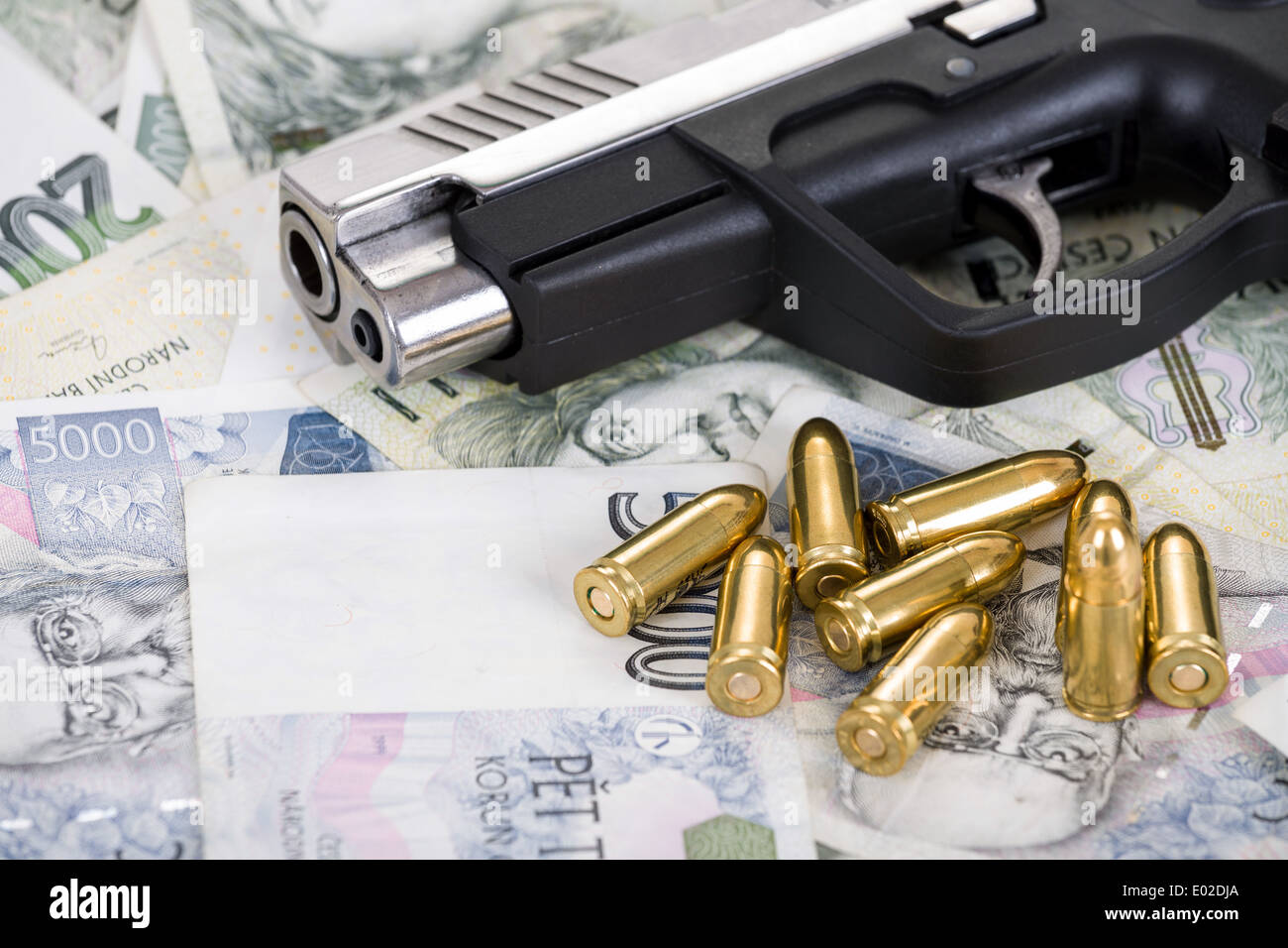 detail of gun with bullet on czech banknotes background Stock Photo - Alamy