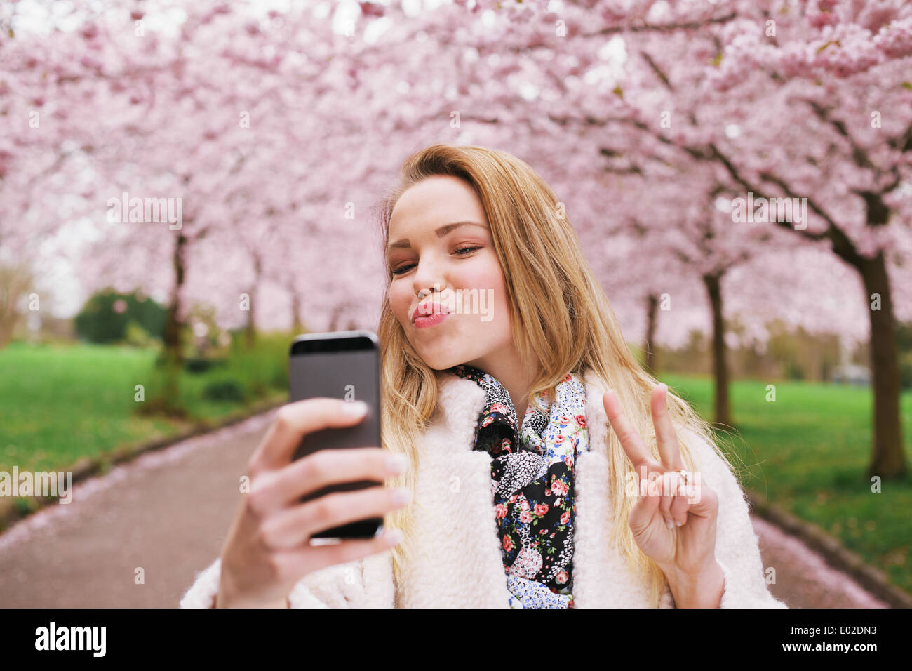 Attractive young woman posing for selfie. Beautiful female at spring ...