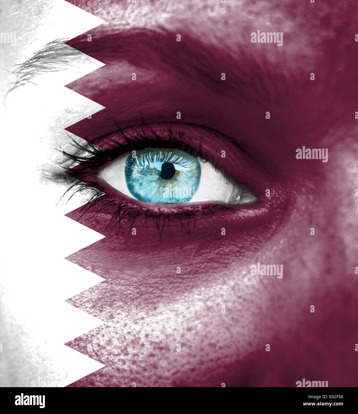 Woman face painted with flag of Qatar Stock Photo - Alamy