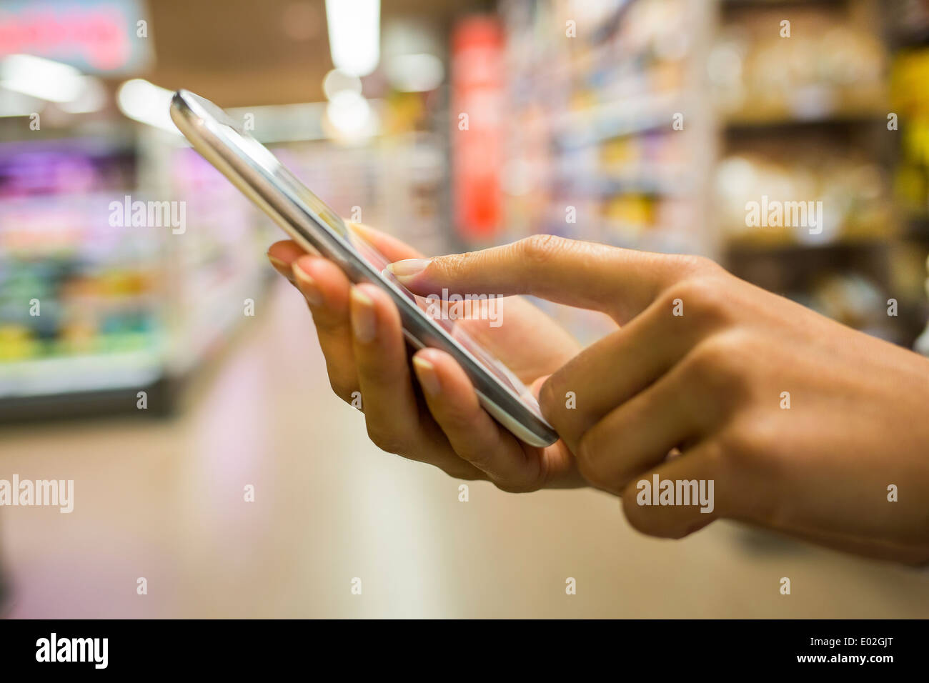 Female store cell phone close-up Stock Photo - Alamy