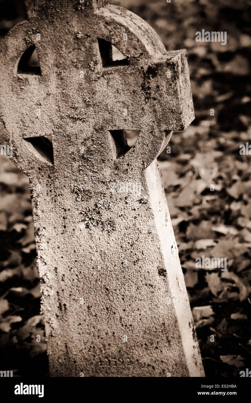 Close up of old tombstone with cross in graveyard, Sweden Stock Photo ...