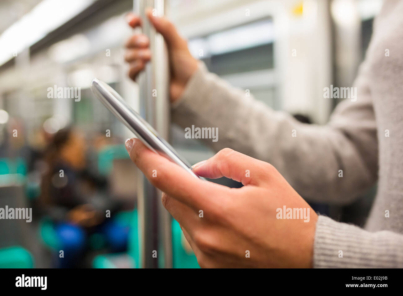 Female smartphone hand underground message sms e-mail Stock Photo - Alamy