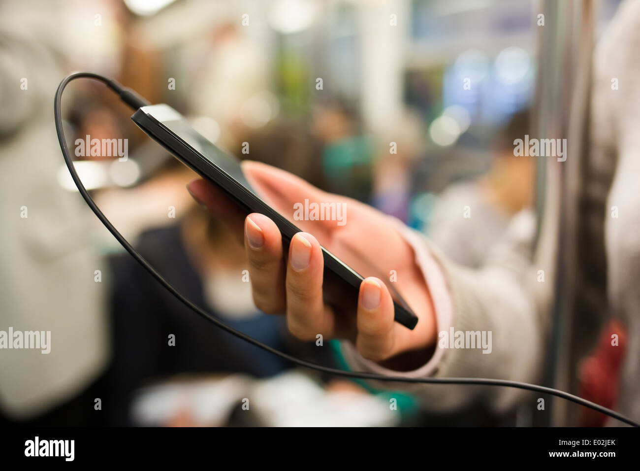 Female smartphone hand underground Stock Photo - Alamy