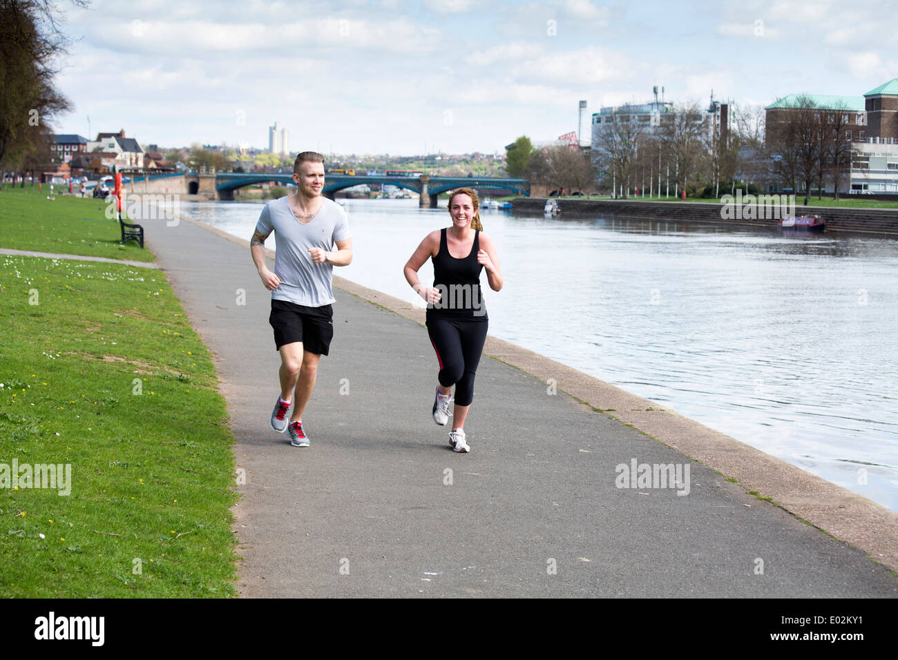 Two joggers running along the Embankment next to the River Trent in ...