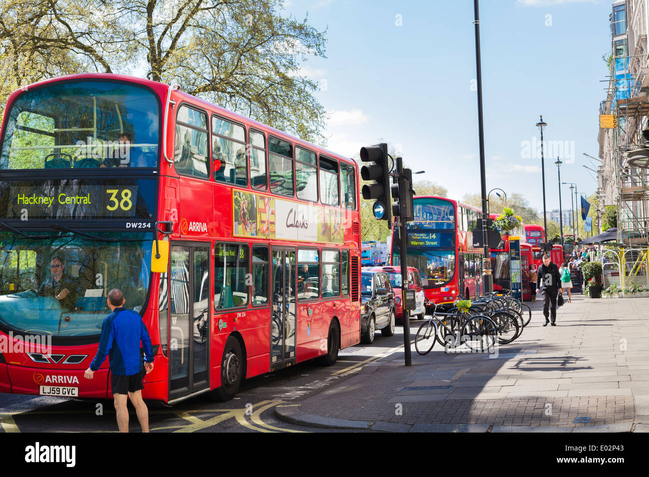 Red London buses in slow moving traffic Stock Photo - Alamy