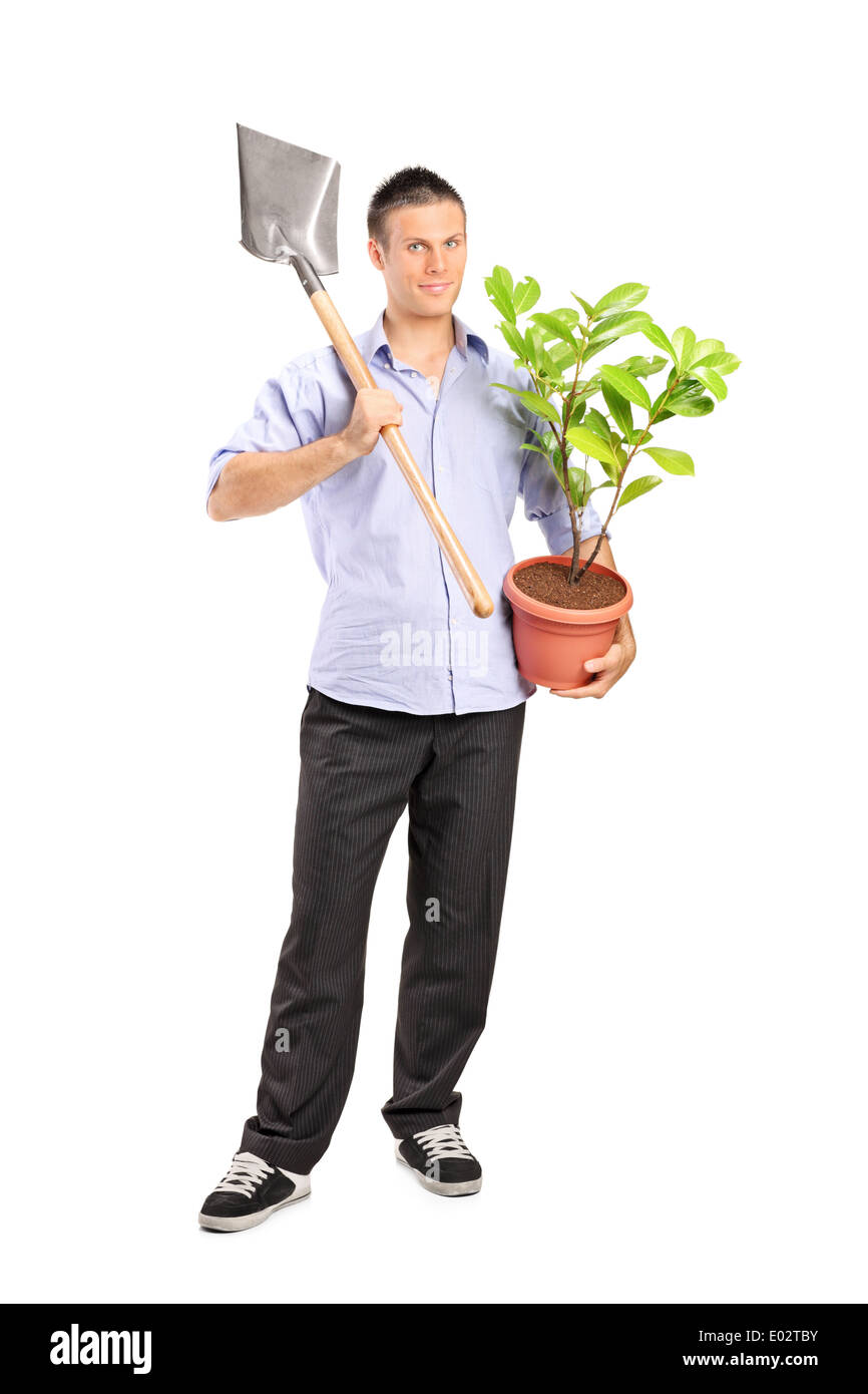 Man holding a shovel and a plant Stock Photo - Alamy
