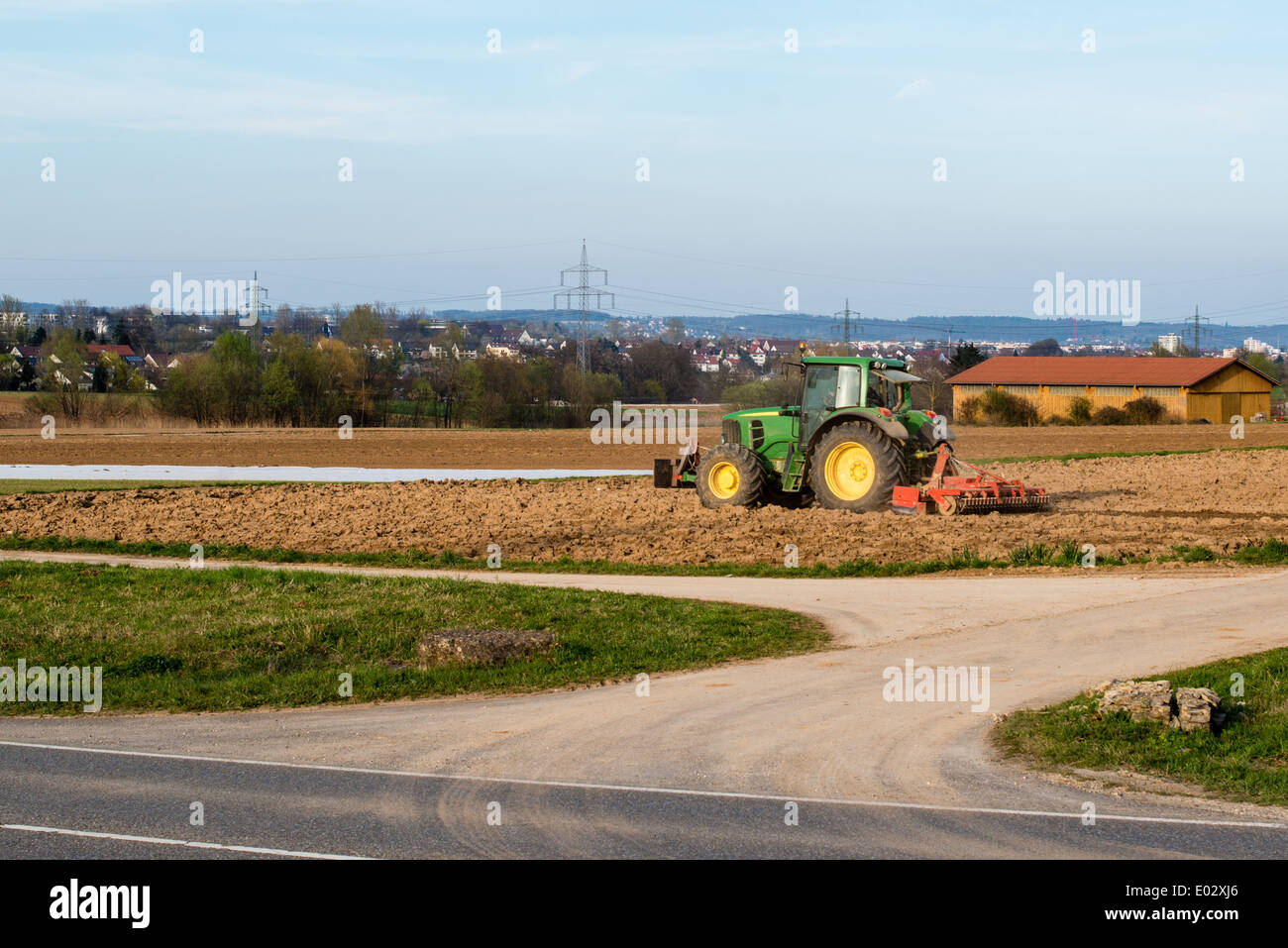 Tractor plowing a field Stock Photo - Alamy