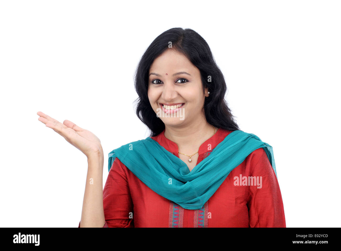 Happy young woman gesturing an open hand against white background Stock ...