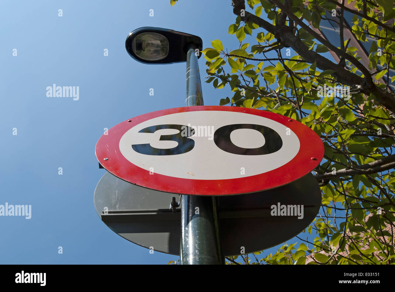 british 30mph speed limit sign attached to a lamppost Stock Photo - Alamy
