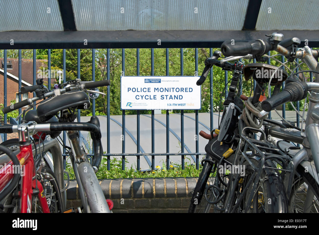 police monitored cycle stand sign by parked bikes at twickenham station ...