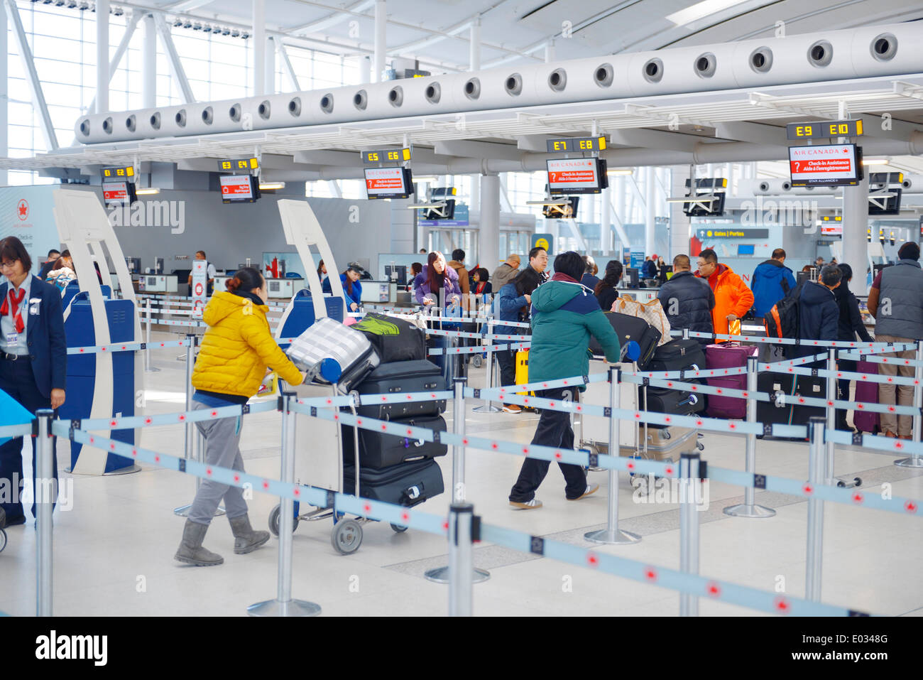 People checking in their baggage at Toronto Pearson International ...