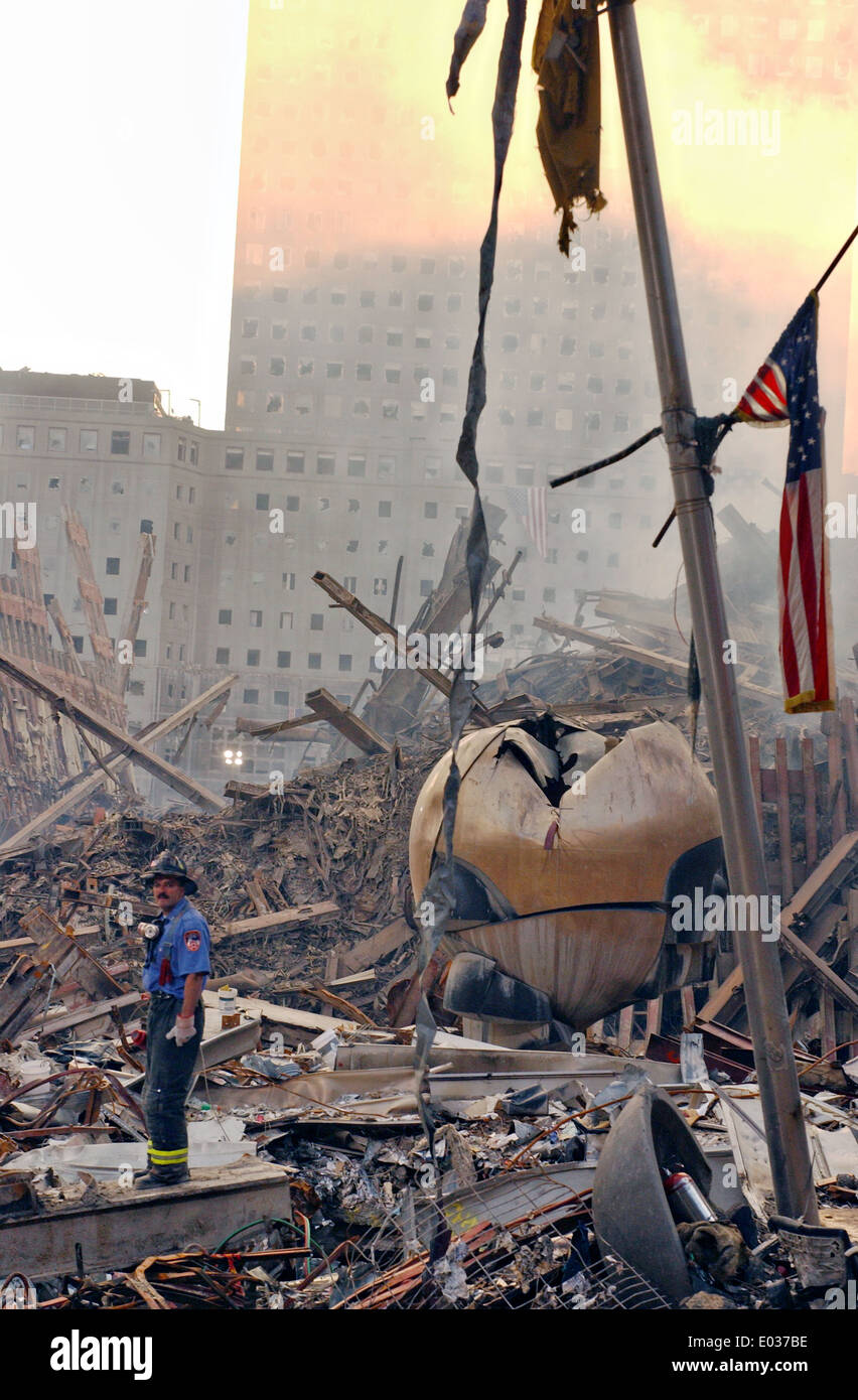 A fireman surveys the destruction as he searches for survivors amongst ...