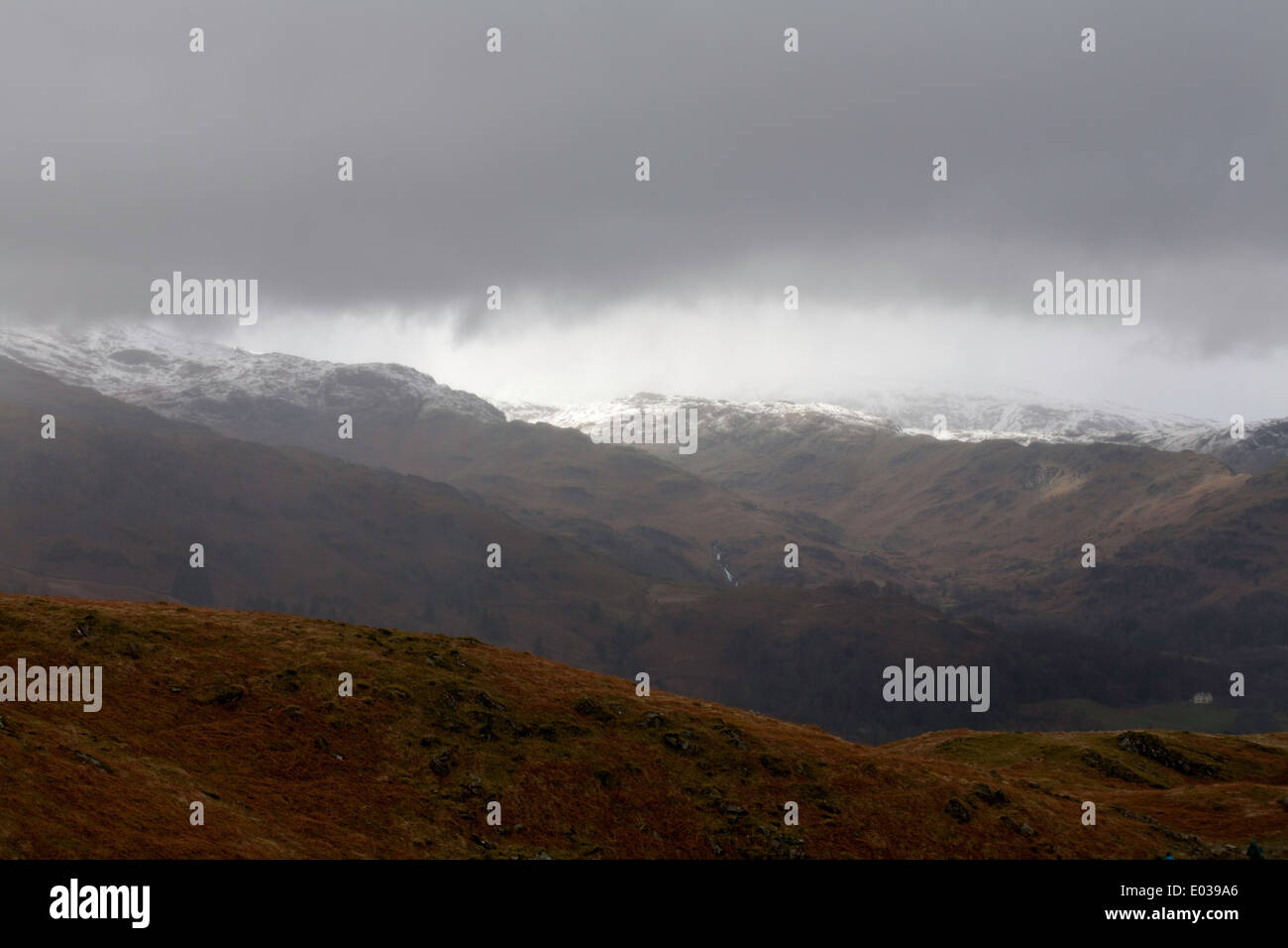 Storm clouds and snow over Wetherlam and The Old Man of Coniston from ...